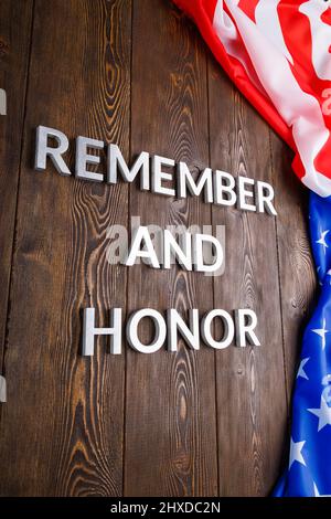 words remember and honor laid with silver metal letters on wooden ...