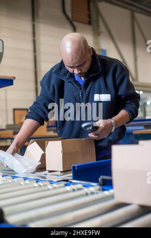 Man using barcode reader in warehouse Stock Photo - Alamy