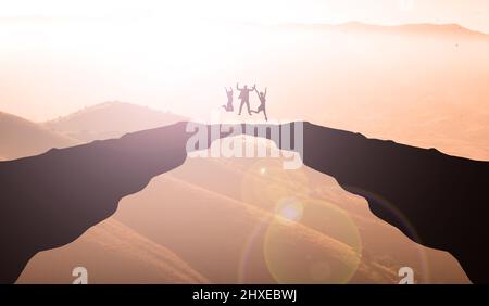 Happy Business Team Jumping Together Over Cliff Maintains at sunset ...
