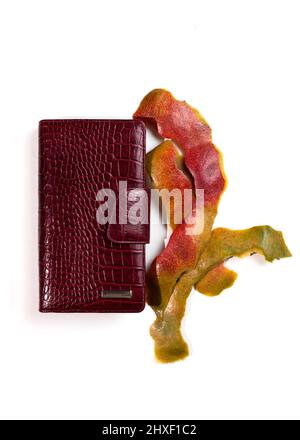 Red purse and mango fruit waste on white background. Vegan ...