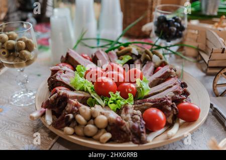 Slicing different types of meat. Meat snacks on the table. wedding ...