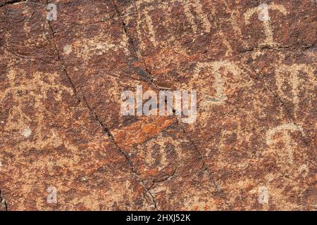 A rock bearing 26 petroglyphs across four faces in Wadi Saham in the ...
