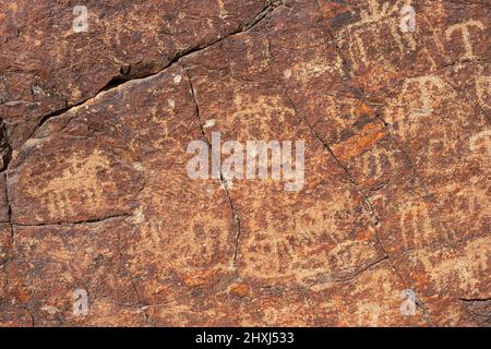 A rock bearing 26 petroglyphs across four faces in Wadi Saham in the ...