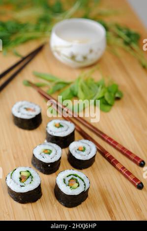 Sushi rolls on cutting board. Selective focus Stock Photo - Alamy