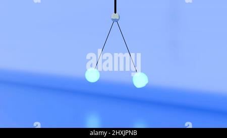 Pendulum of two balls. Design. Animation with two balls on ropes ...