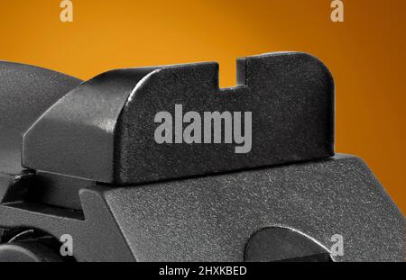 Pistol rear sight on an orange background with drop shadow Stock Photo ...