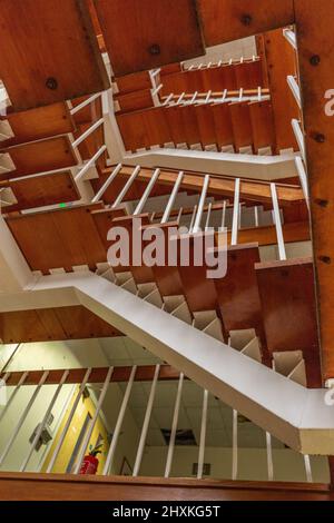 Wood and metal staircase inside Ashdown House, Hastings. Former DWP ...