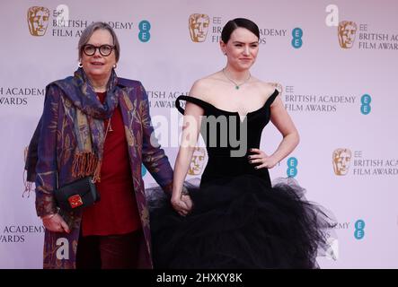 Louise Fawkner-Corbett and Daisy Ridley pose for photographers upon ...