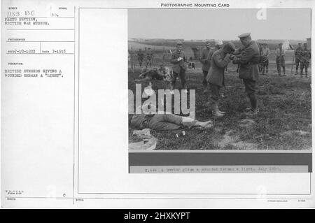 British soldier giving wounded German prisoner a drink 1916 Stock Photo ...