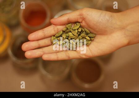 cardamom, cumin, star anise on beautiful woman hand Stock Photo - Alamy