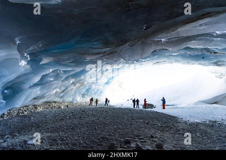 Hikers with snowshoes in Zinal glacier cave in Switzerland Stock Photo ...