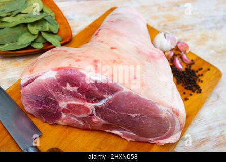 Raw pork leg with herbs and condiments ready for cooking Stock Photo ...
