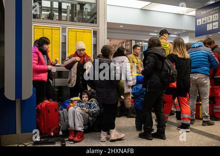 Refugees are seen waiting for a train at the railway station. Refugees ...