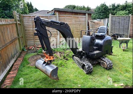 A small garden digger parked ready for use Stock Photo - Alamy