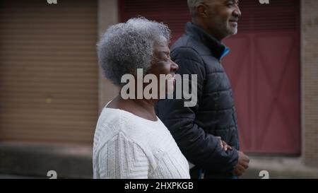 Generational relationship father and 80s mother walking together in ...