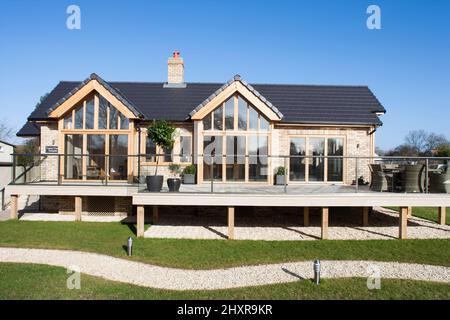 single storey house built on a raised platform above flood plain Stock ...
