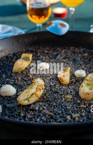 Closeup of Black rice with cuttlefish and young garlic in Spain Stock ...