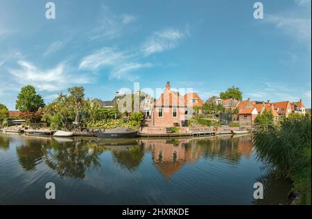Houses with a garden at the bank of the canal Winsumerdiep, Winsum ...