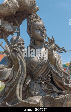 Vertical photo of bronze statues of a Japanese character representing ...
