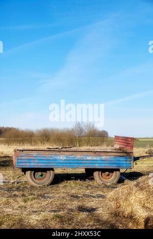 An old empty tractor trailer on a field Stock Photo - Alamy