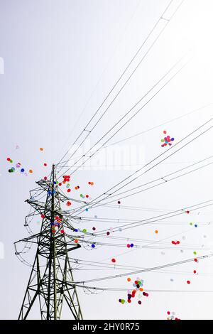 Balloons flying through electrical power lines Stock Photo - Alamy