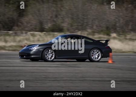 Black Porsche car racing on a runway in Washington Stock Photo - Alamy