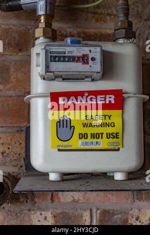 A gas meter with a danger safety warning sticker Stock Photo - Alamy