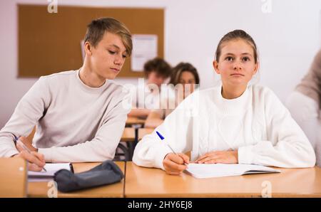Teenagers doing tasks during lesson in school Stock Photo - Alamy