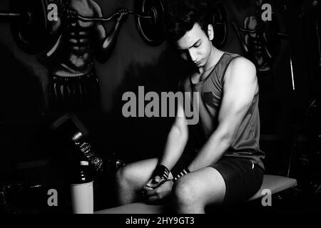 Grayscale of a young Indian male doing exercise in a gym Stock Photo ...