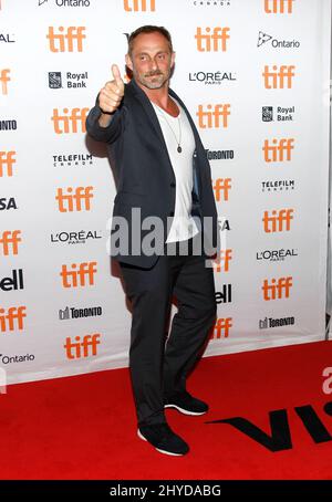 Roland Moller arriving at the "Papillon" premiere at the 2017 Toronto ...