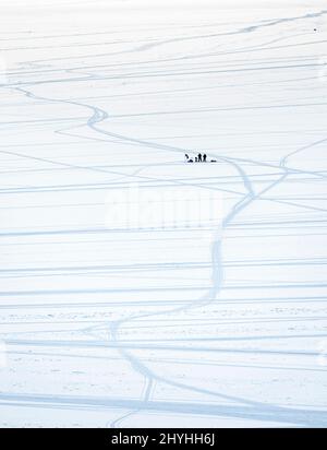 Snowmobile of an Inuit on the sea ice of a frozen fjord near Saatut ...