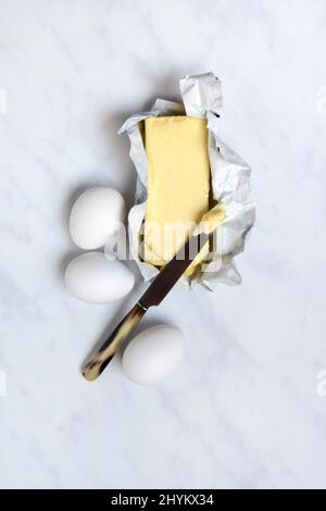 Butter in opened packaging and eggs Stock Photo - Alamy