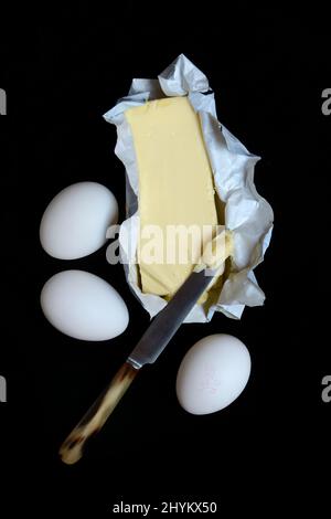 Butter in opened packaging and eggs Stock Photo - Alamy