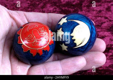 Qi-Gong balls in the hand Stock Photo - Alamy