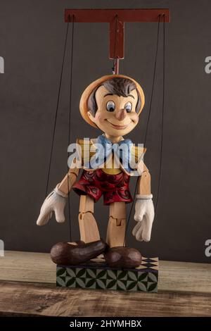 Vintage wooden Pinocchio string puppet in the window of an antique shop ...