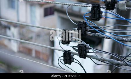 Messy wires from electric poles chaotic mess Stock Photo - Alamy
