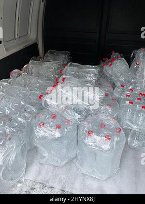 Opened car trunk with packages of food, paint and cable roll for ...