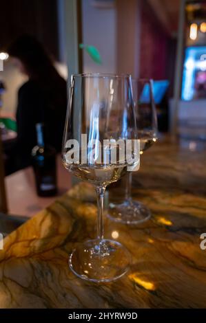 Glass of cold dry Italian pinot grigio white wine served in Italian bar ...