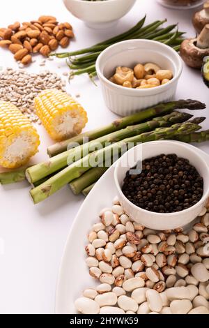 High angle view of various healthy food and ingredients on white table ...