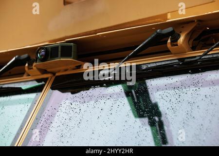 Wipers on the windshield of an armored car. Drops on the windshield ...
