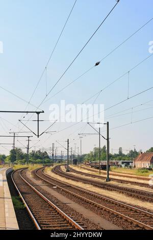 Perspective view of empty train tracks and concrete platform under ...
