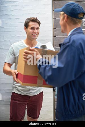 Positive young man receiving boxes delivered by courier Stock Photo - Alamy
