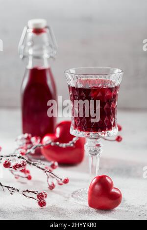 Red cocktail, vodka or liqueur and Heart shape decorations Stock Photo ...
