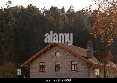 A beautiful huge house. Triangle roof. Stone house in autumn season ...