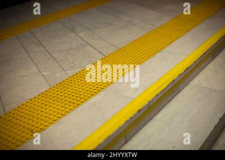 Surface for visually impaired. Yellow limiter for blind. Markings on ...