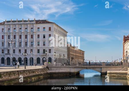 Ponte Rosso bridge and historic buildings reflected in the still water ...