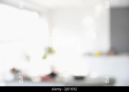 Blurred view of light kitchen with counters and window Stock Photo - Alamy