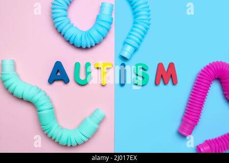 Word AUTISM with Pop Tubes on color background Stock Photo - Alamy