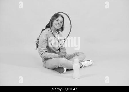 sport teen kid in fitness cap holding tennis or badminton racket ...