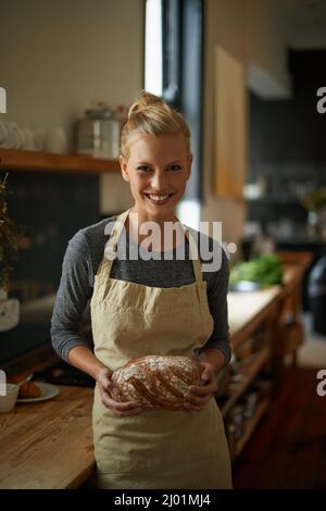 Making her own bread. a female baker kneading dough for homemade bread ...